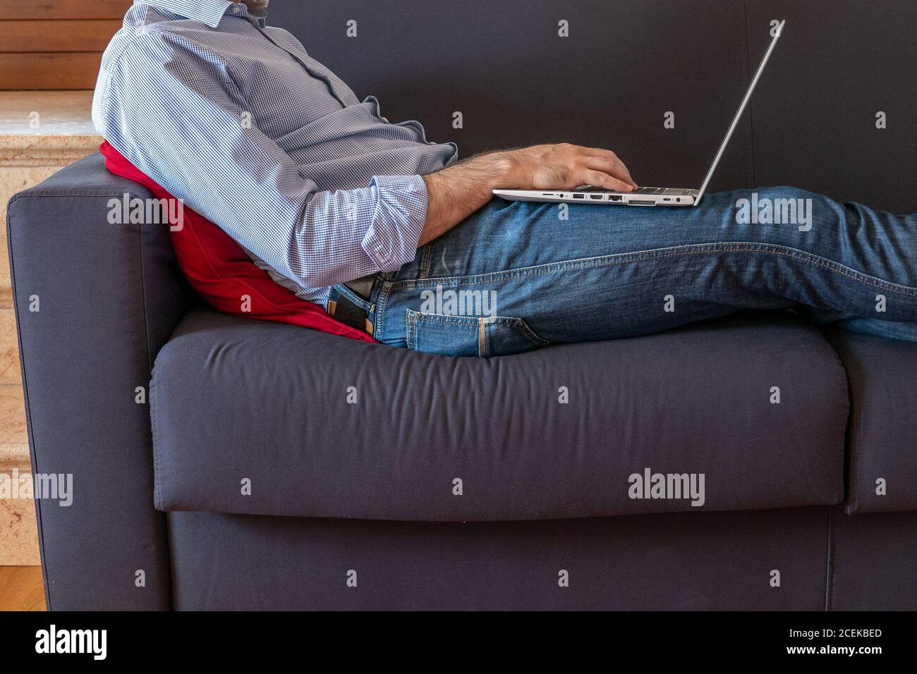 Man sitting on sofa works hi-res stock photography and images - Alamy