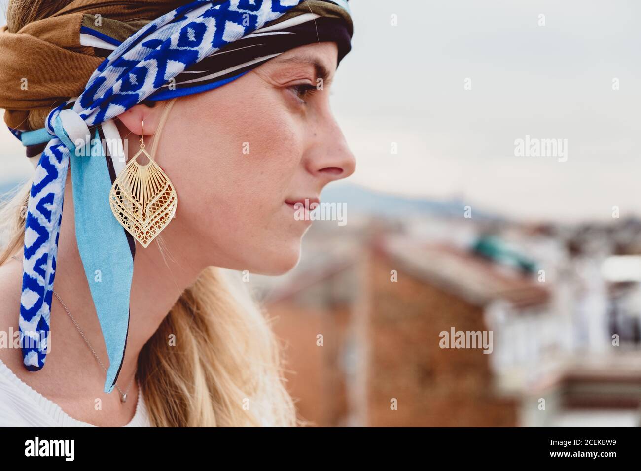 Woman in head cloth standing on rooftop Stock Photo - Alamy
