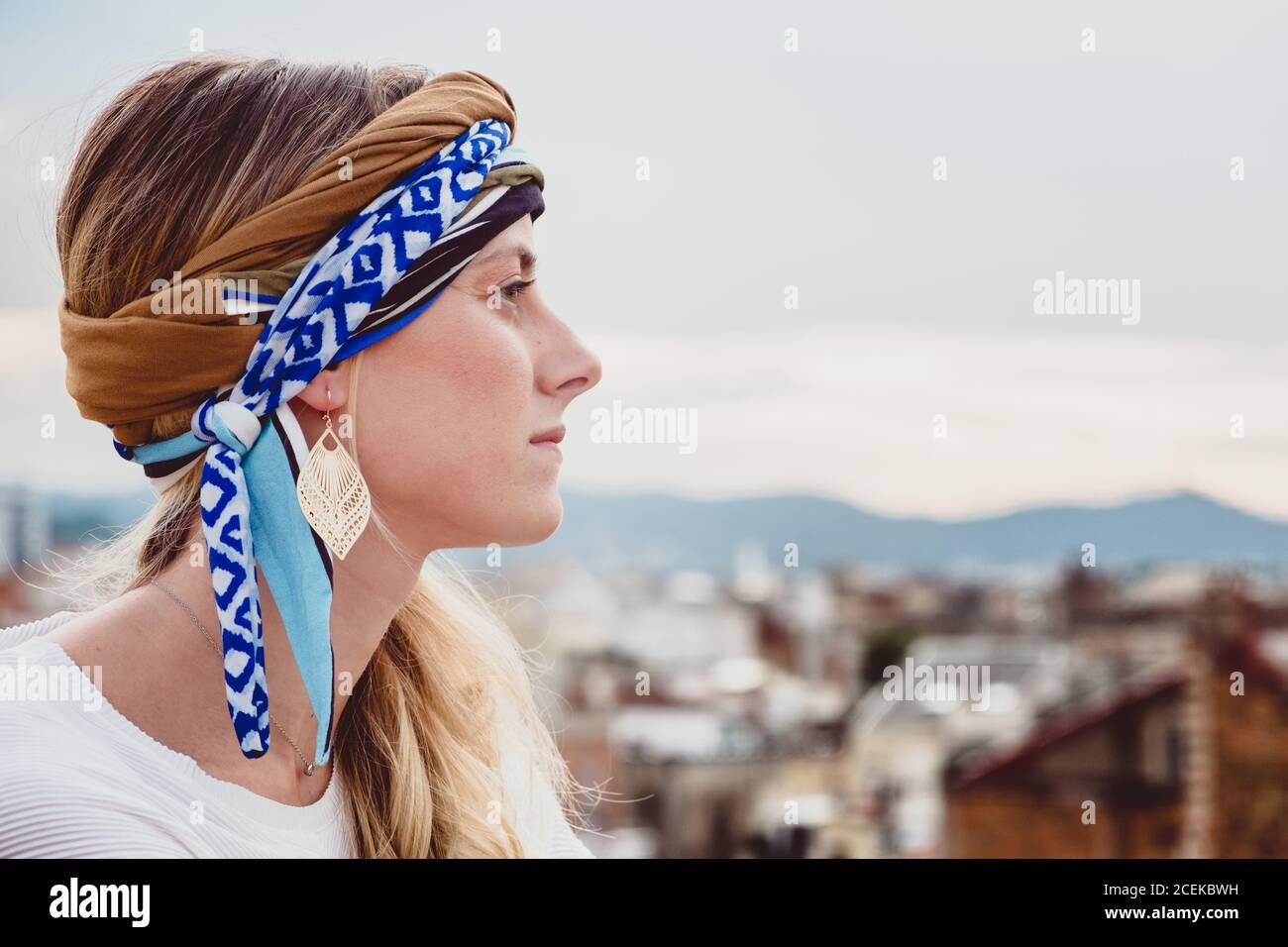 Woman in head cloth standing on rooftop Stock Photo - Alamy