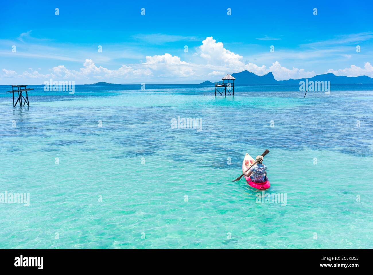 Back view male boating on canoe with paddle on amazing azure sea and ...