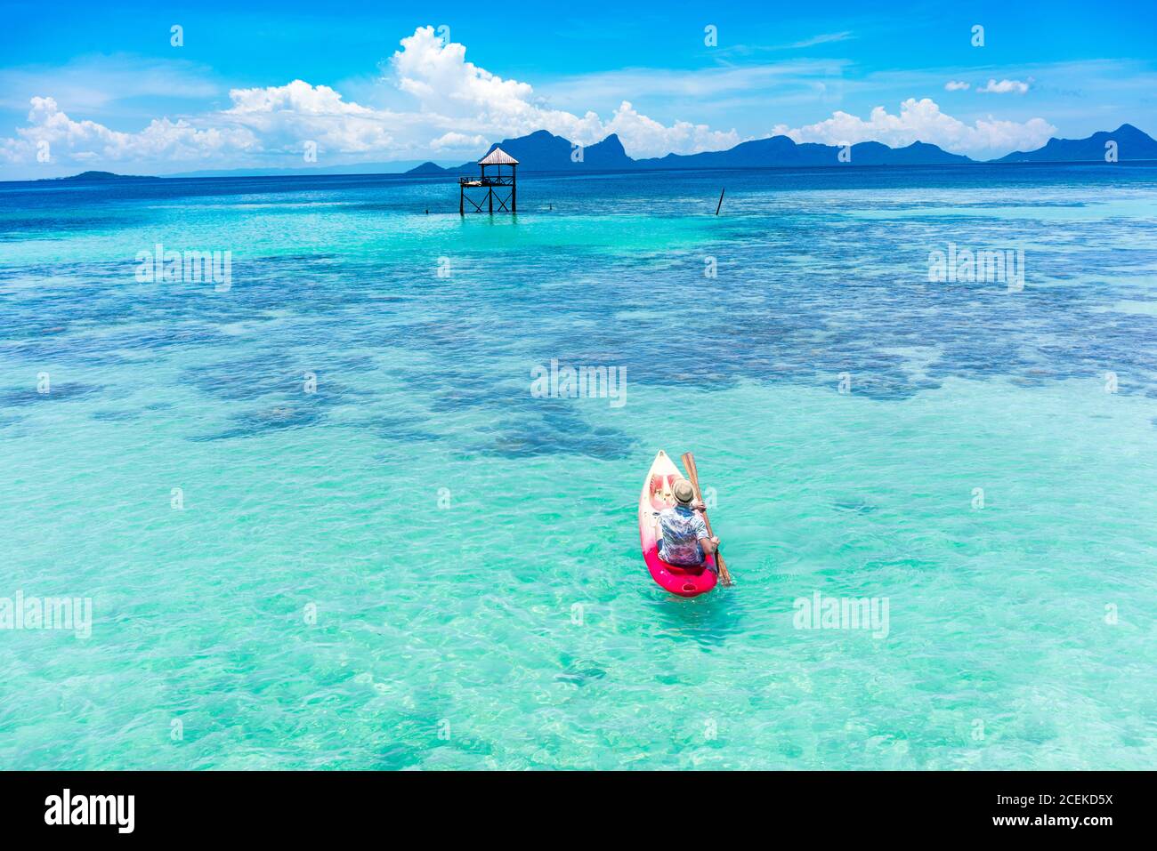 Back view male boating on canoe with paddle on amazing azure sea and ...