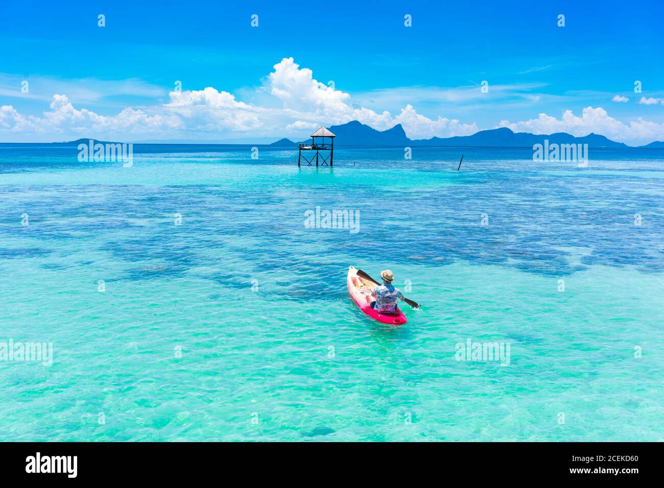 Back view male boating on canoe with paddle on amazing azure sea and ...