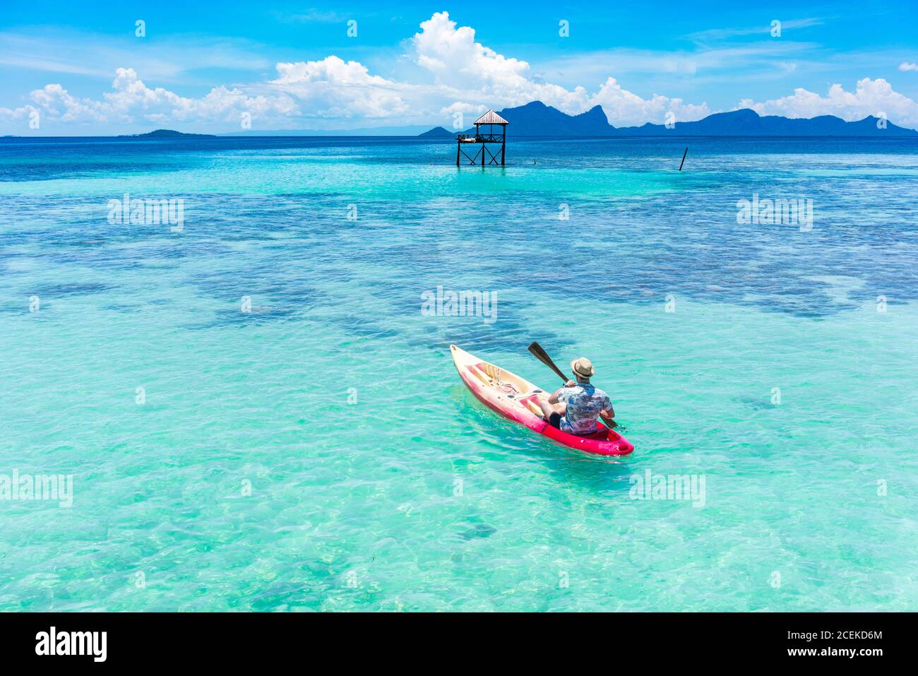 Back view male boating on canoe with paddle on amazing azure sea and ...