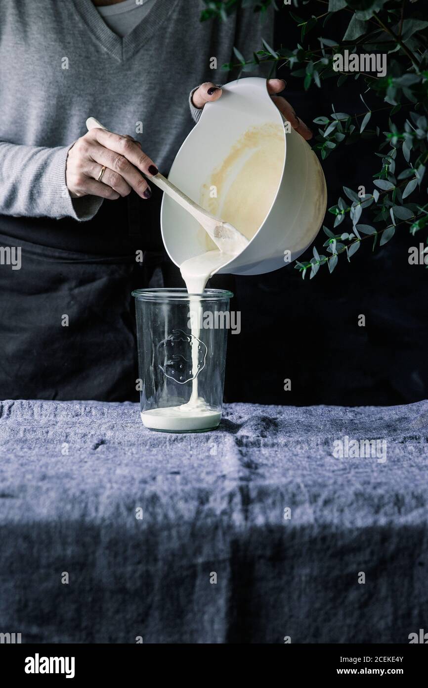 unrecognizable person standing and pouring dough to the jar Stock Photo ...