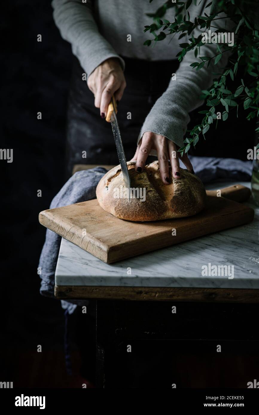 Person slicing fresh bread hi-res stock photography and images - Alamy