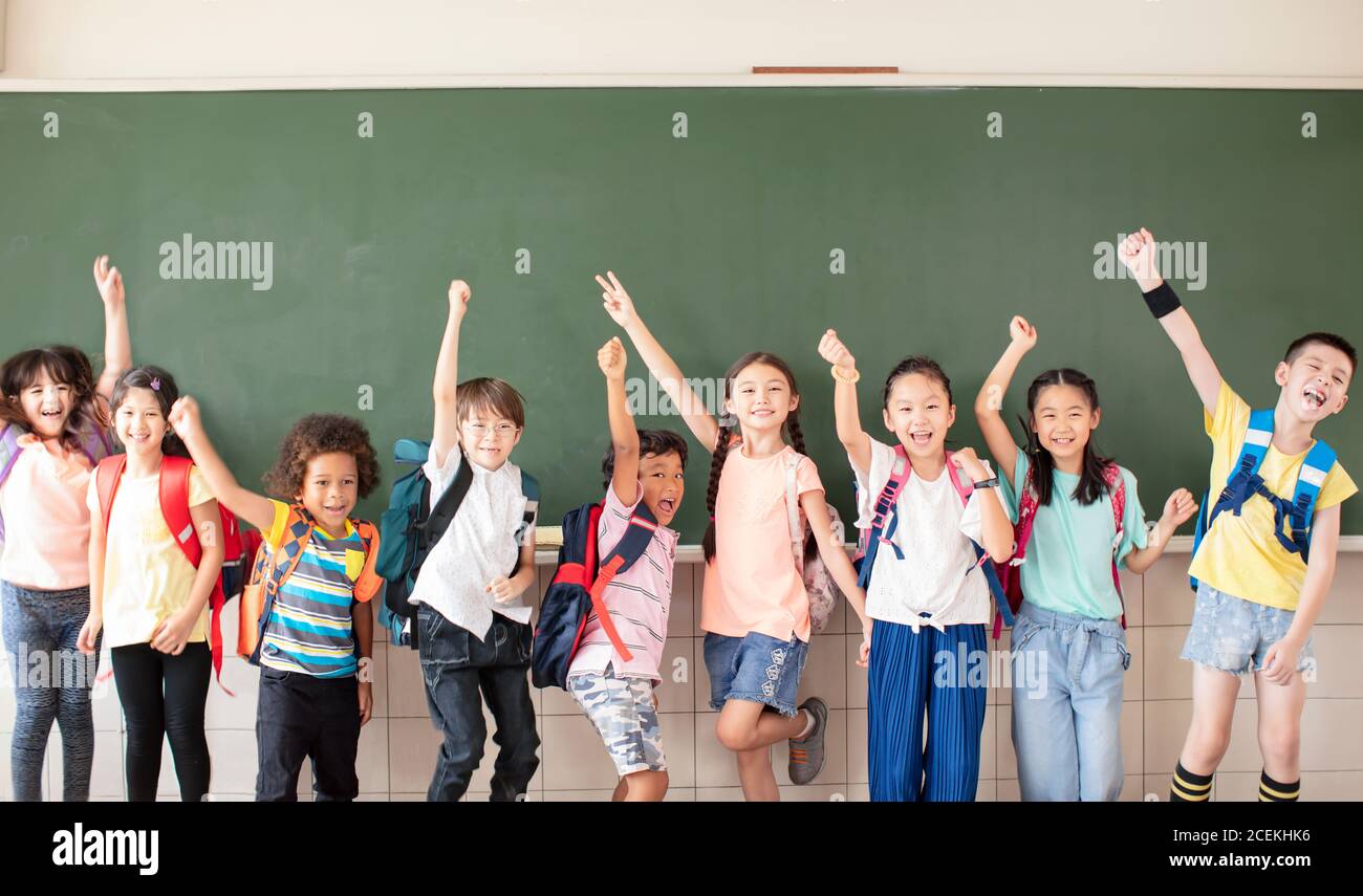 Group of diverse young students standing together in classroom Stock ...
