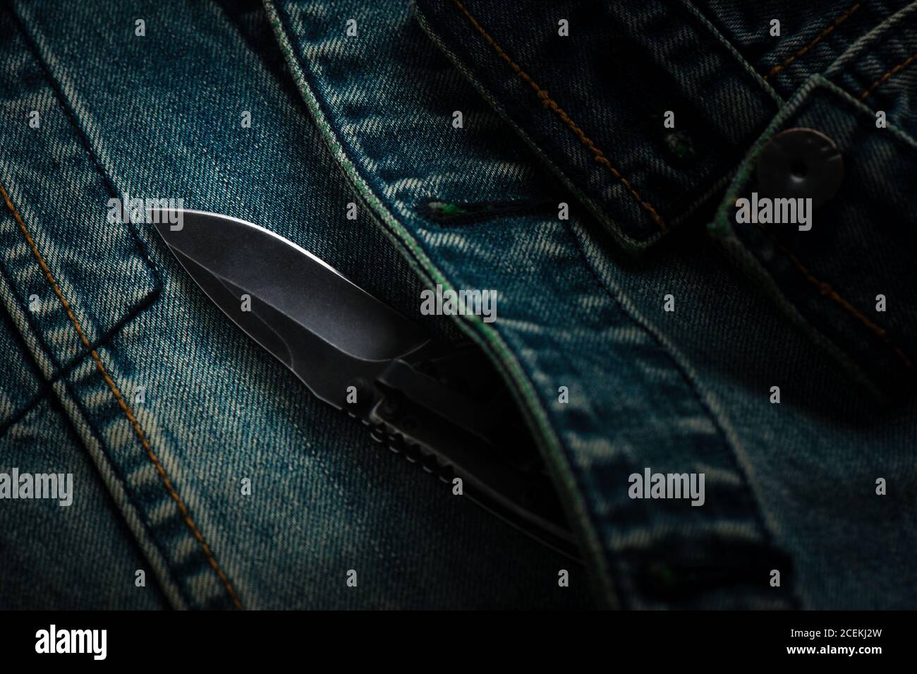 stainless steel folding knife over denim jacket Stock Photo - Alamy
