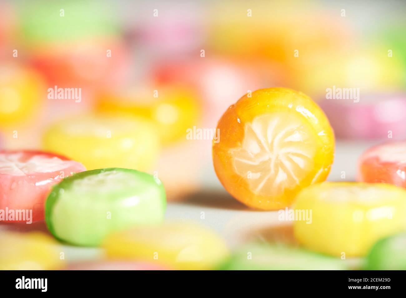 Candies of varied colors and flavors; an orange one stands out among ...