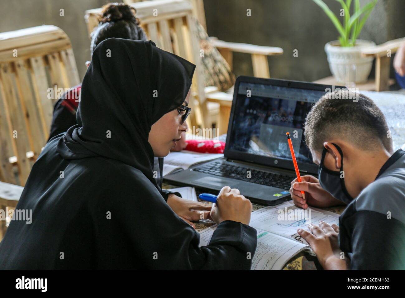 Gaza. 1st Sep, 2020. A Palestinian woman teaches her child inside their ...