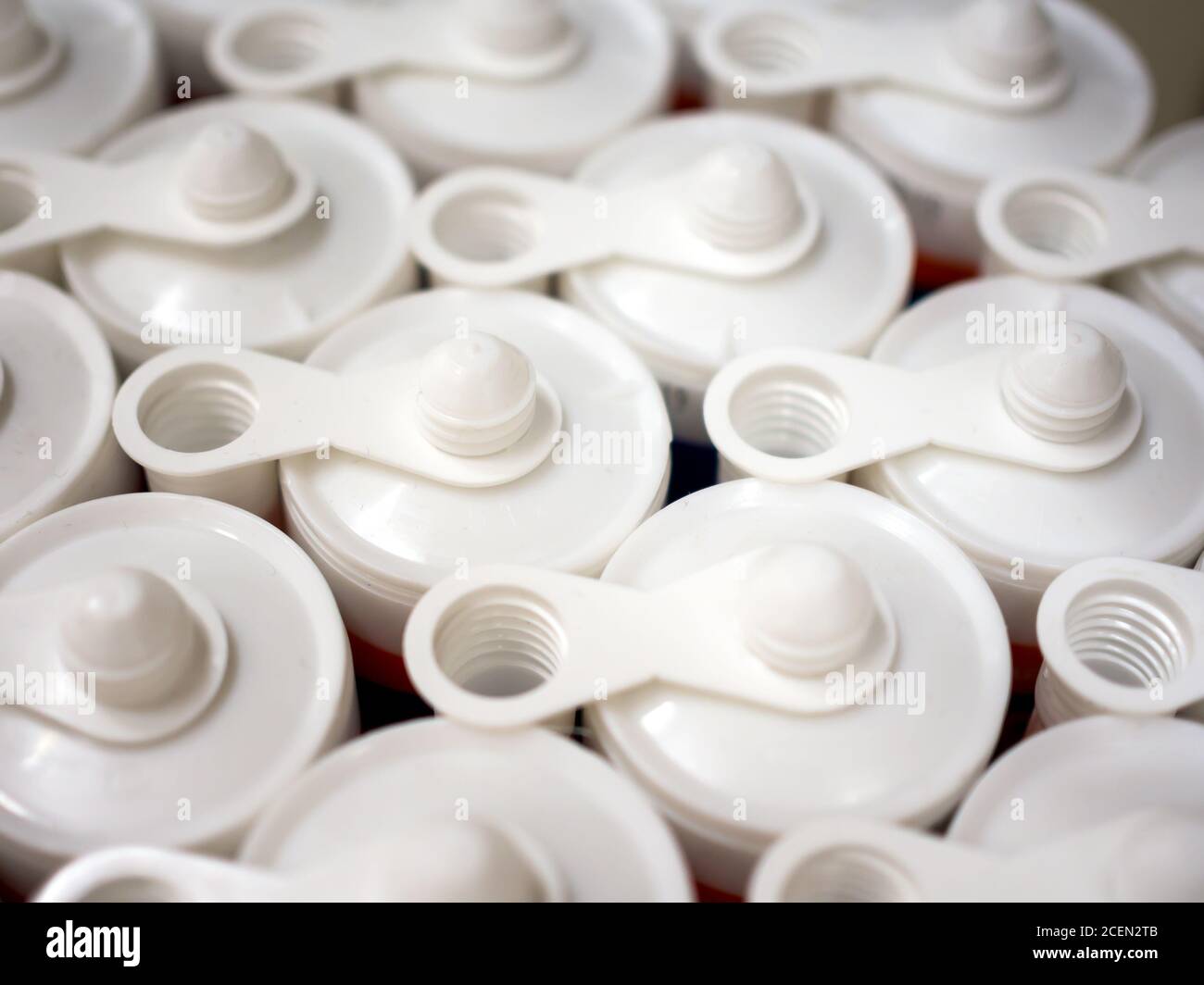 Rows of plastic tubes with sealant Stock Photo - Alamy