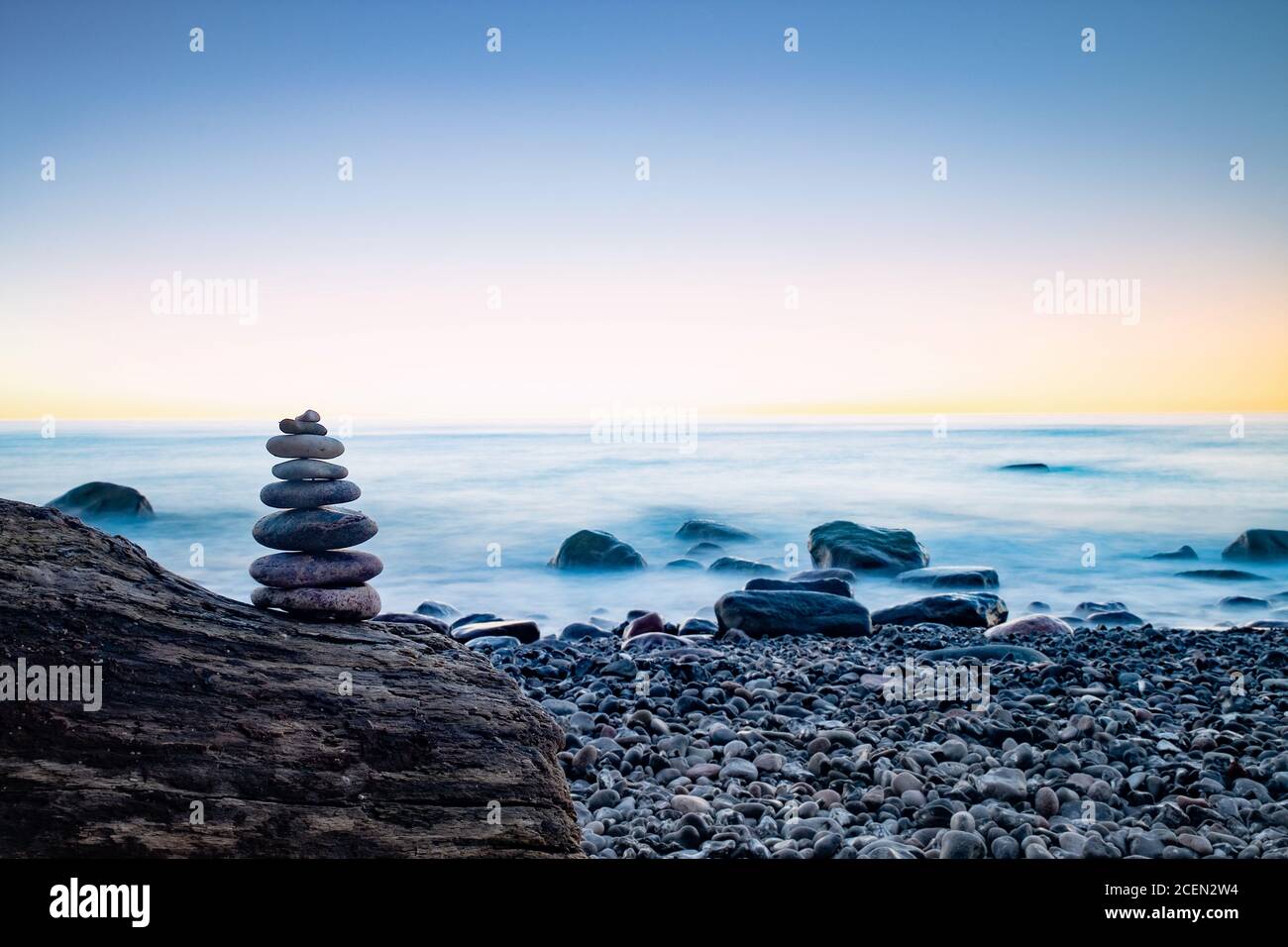 Pyramid of sea stones on pebbles of the sea shore. Seascape. The ...