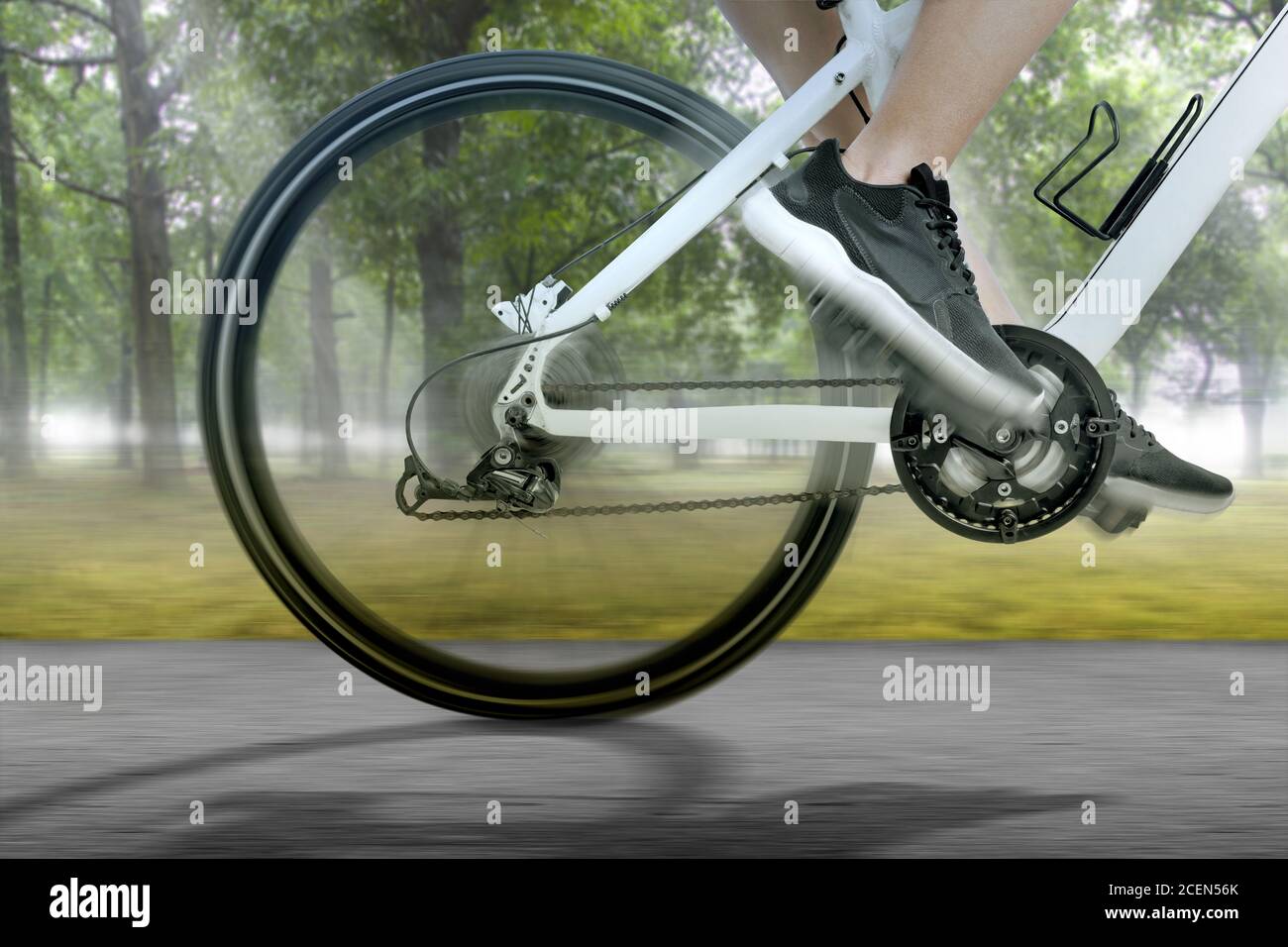 Side view of a woman riding a bicycle on the street Stock Photo - Alamy