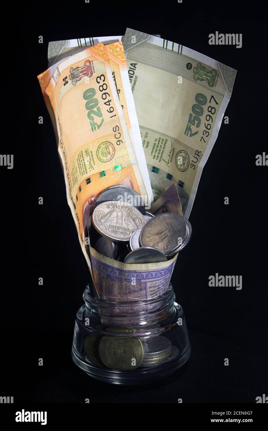 New and old Indian currencies. 50, 100, 200, 500 rupee notes and coins ...