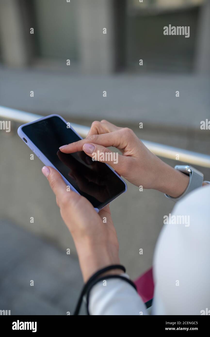 Woman touching the screen of the smartphone Stock Photo - Alamy