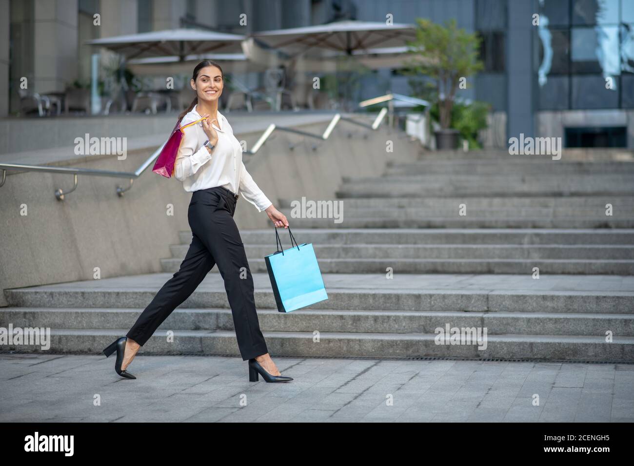 Beautiful stylish woman walking down the street Stock Photo - Alamy