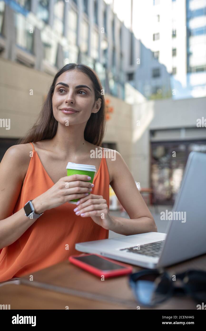 Trendy cute young woman having coffee and feeling good Stock Photo - Alamy