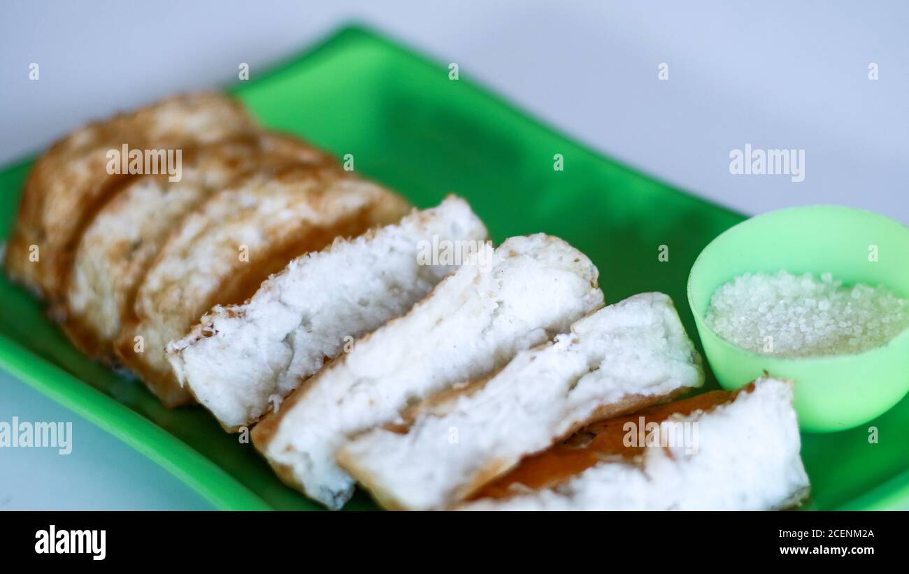 Pancong cake or kue pancong and sugar on white background. Street food ...