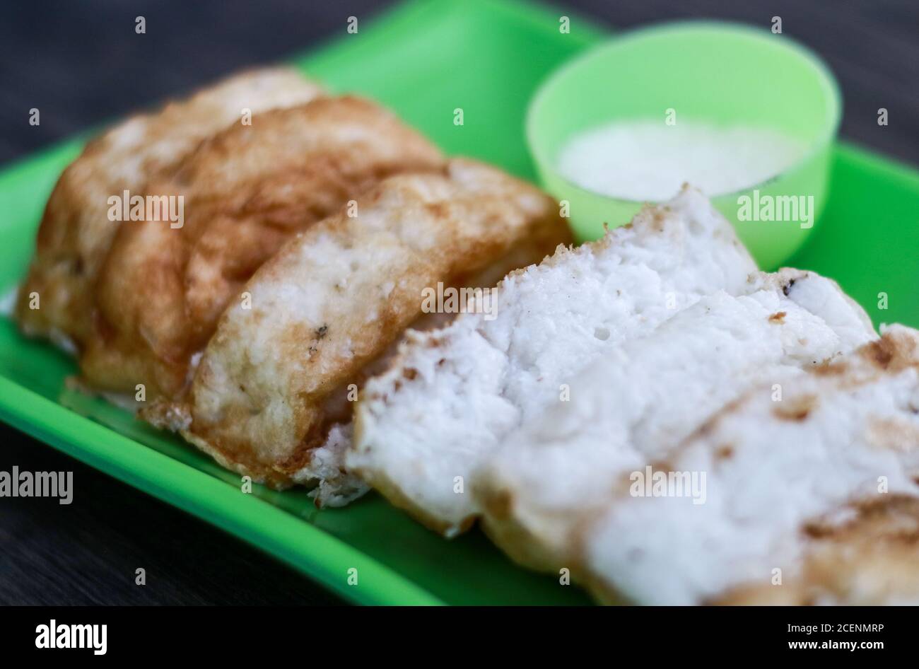 Pancong cake or kue pancong and sugar on wood background. Street food ...