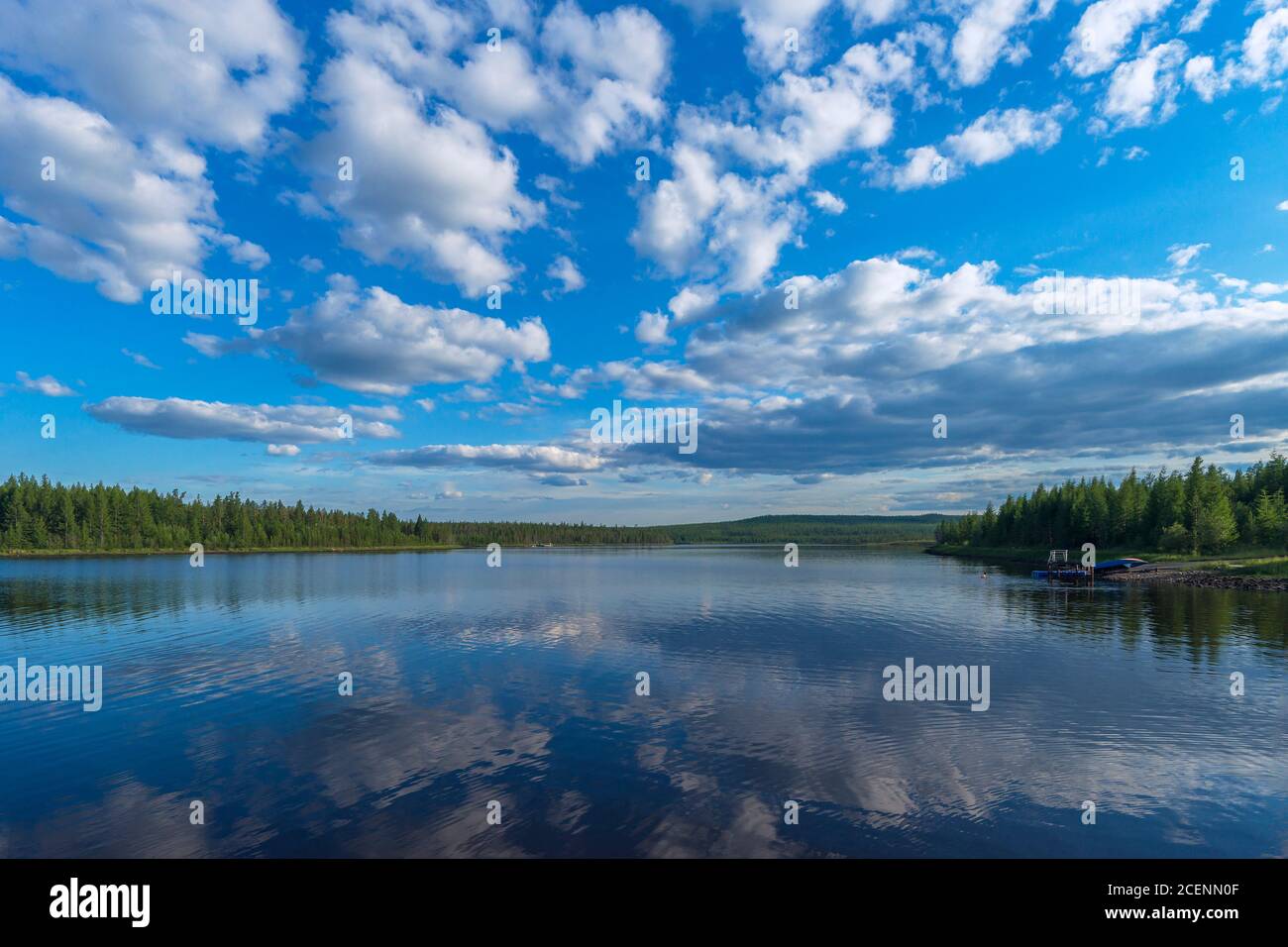 Summer day landscape with river, forest, clouds on the blue sky and sun ...