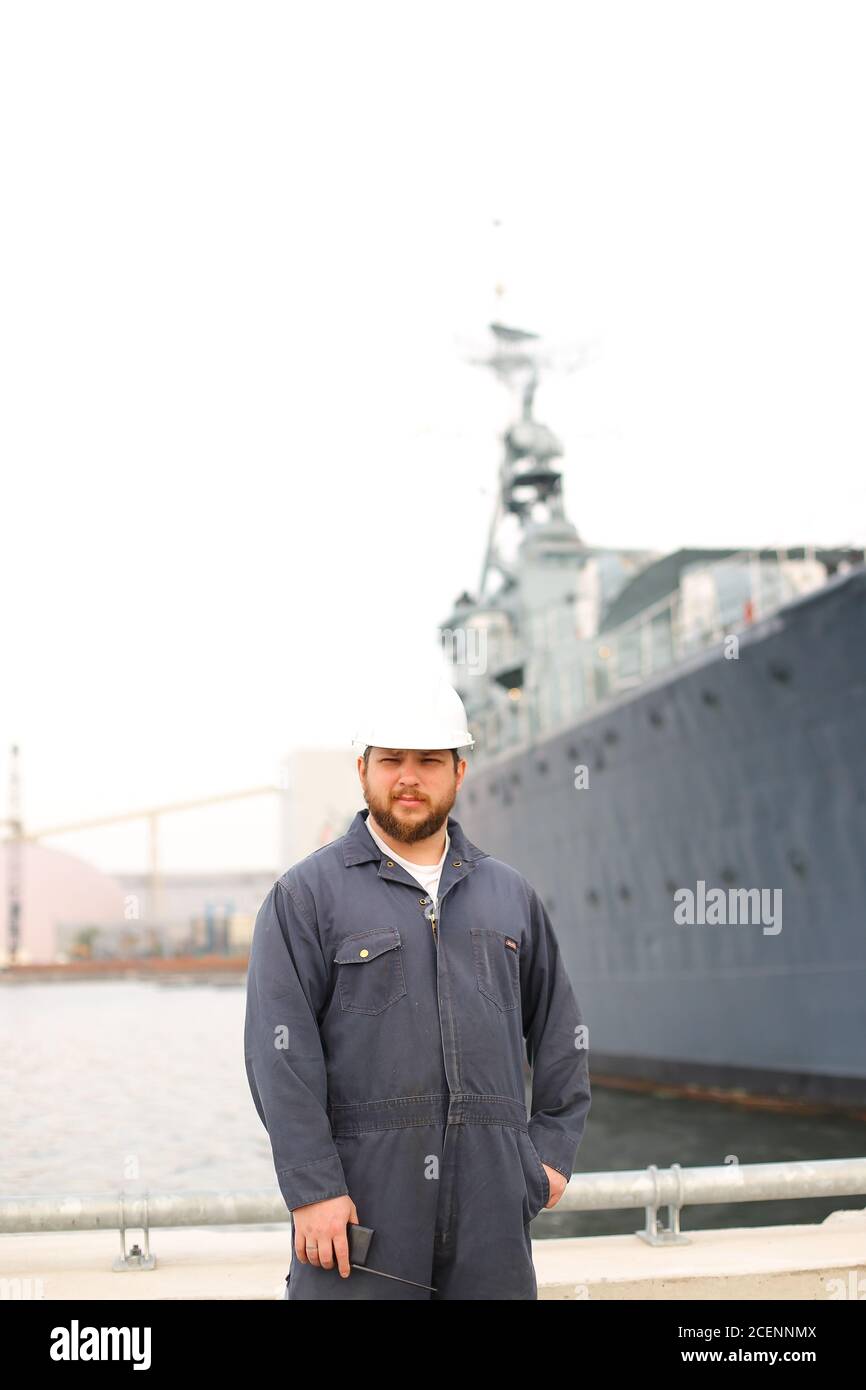 Marine deck officer holding walkie talkie radio and standing near ...