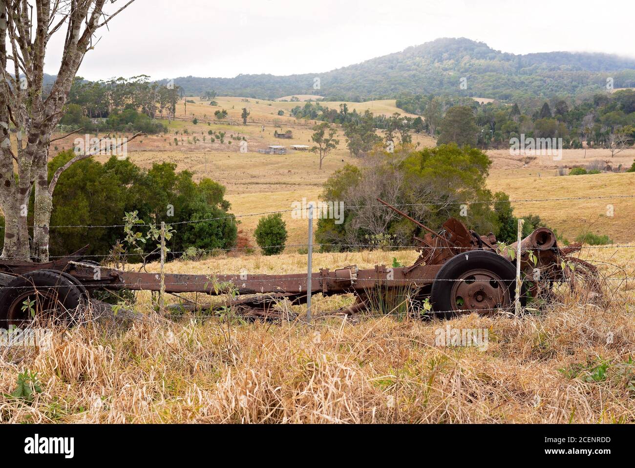 An old discarded truck chassis lying rusting in a country field Stock ...