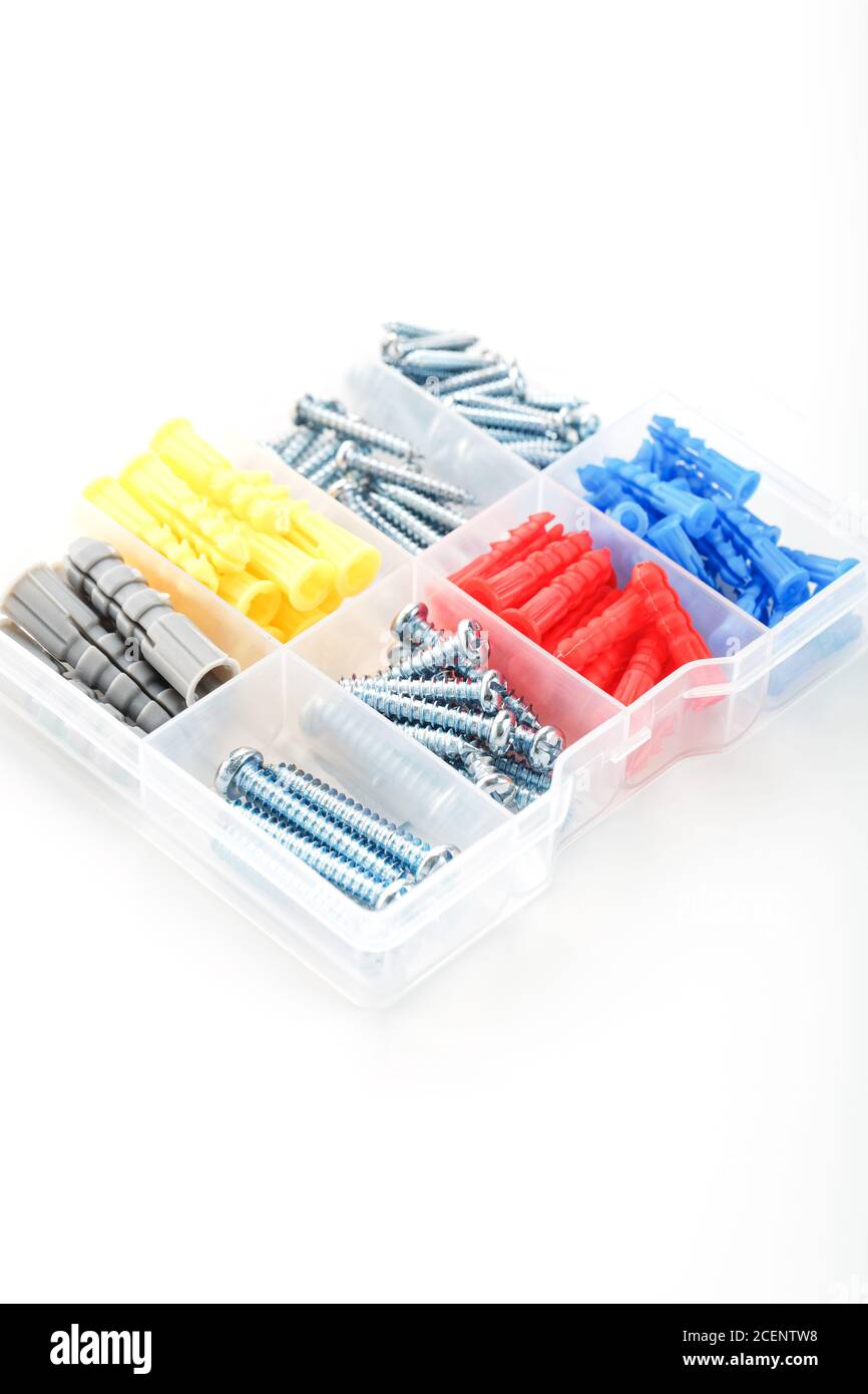 Box with screws and dowels of different sizes, shapes and colors on a ...