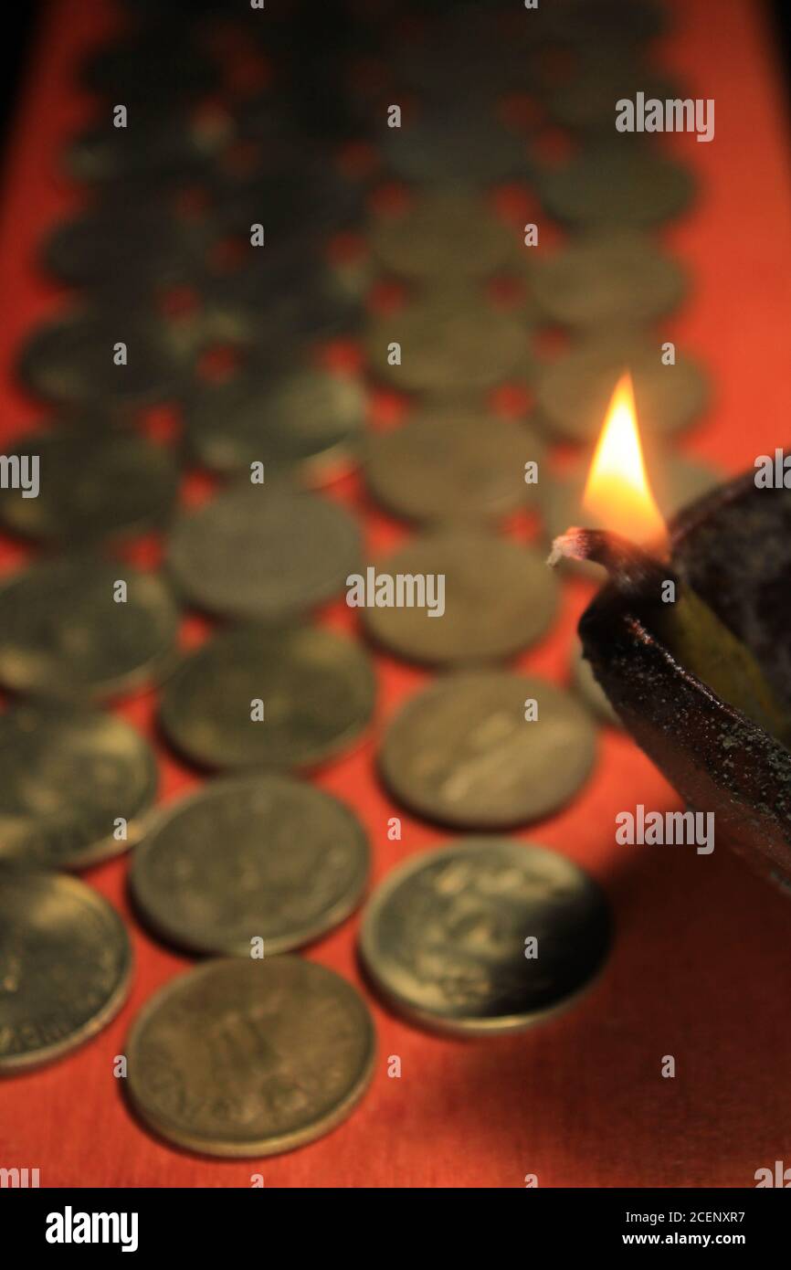 Indian rupee coins with candle light. Stock pile of 1, 2, 5, 10 Indian ...
