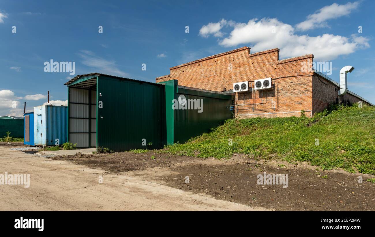 Facade of a metal and brick warehouse, commercial building for storage ...