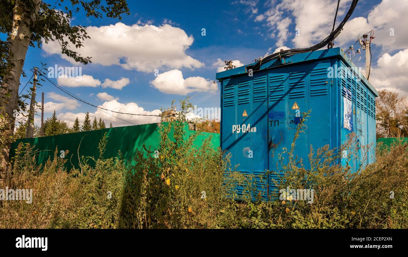 Electric blue transformer room building with doors and hazard signs on ...