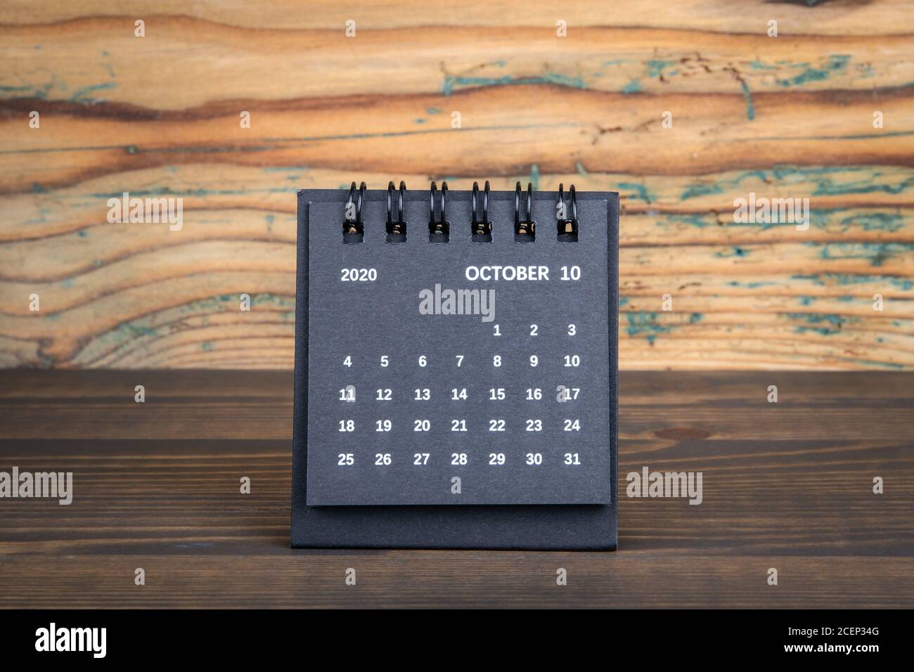 2020 OCTOBER. Black paper calendar on a wooden table. Time planning ...