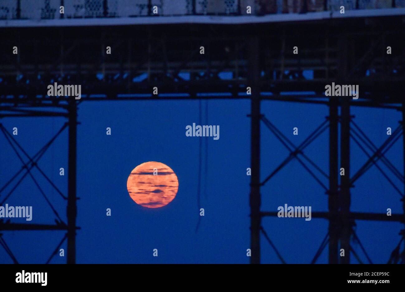 Brighton UK 2nd September 2020 - The full corn moon drops behind ...