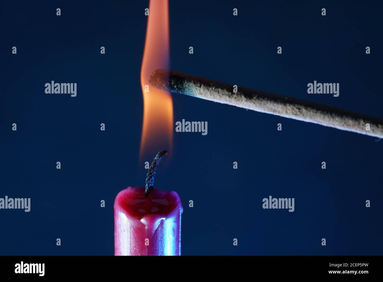 Burning candle and stick Stock Photo - Alamy