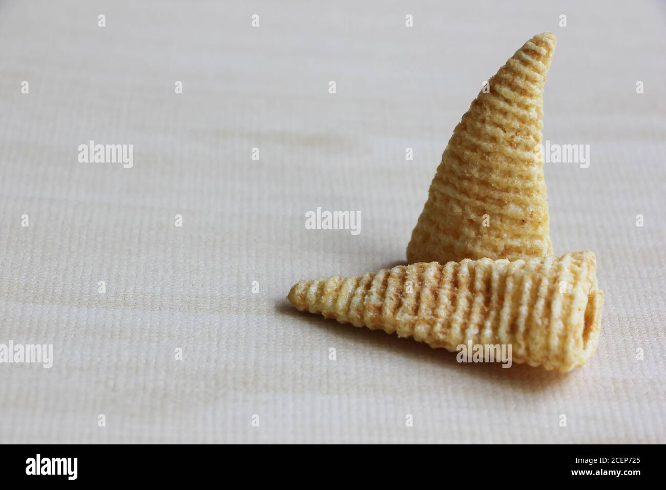 Cone of Corns Snack. Yellow, puffed Stock Photo - Alamy