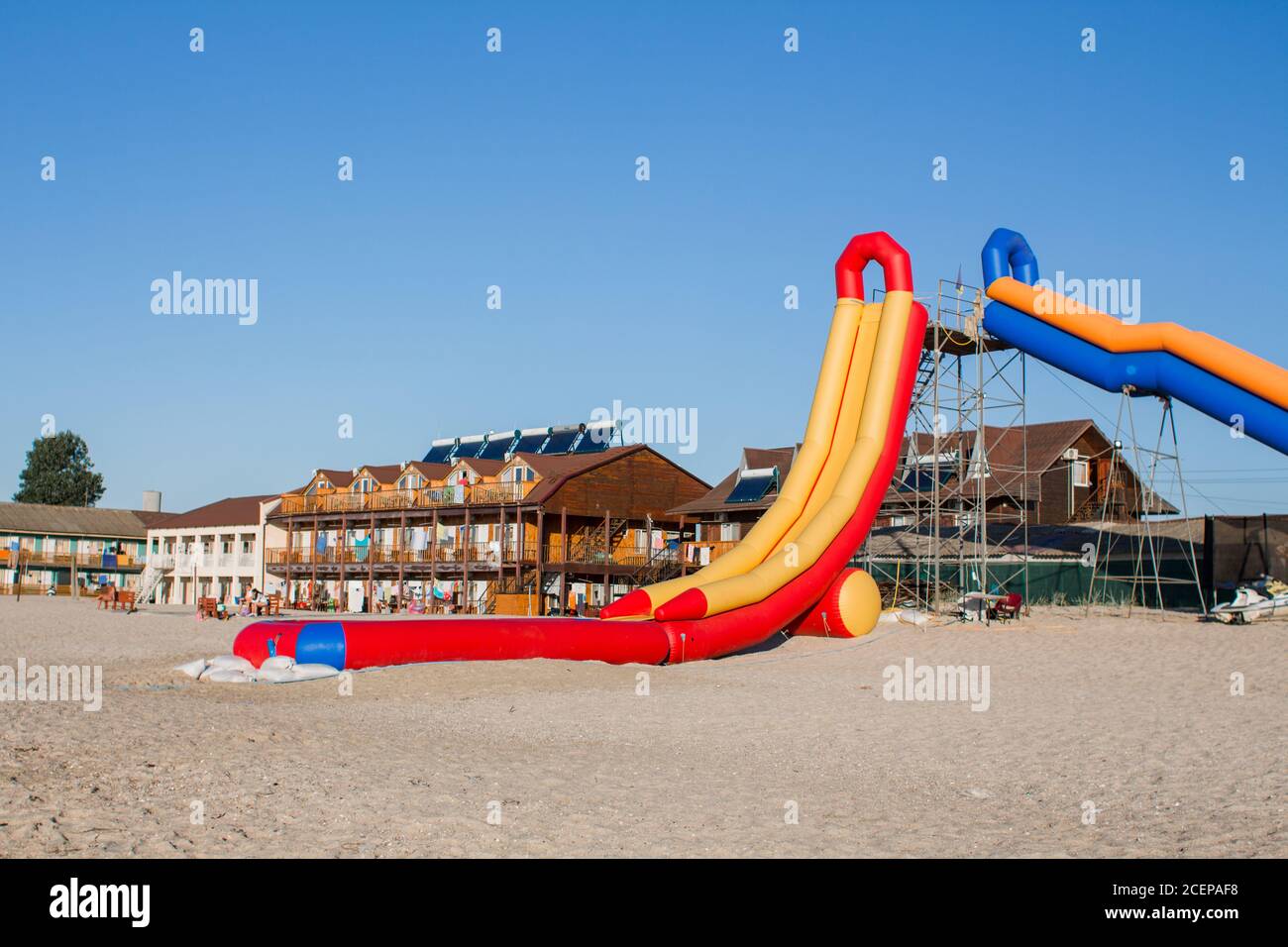 an inflatable water slide on the beach Stock Photo - Alamy