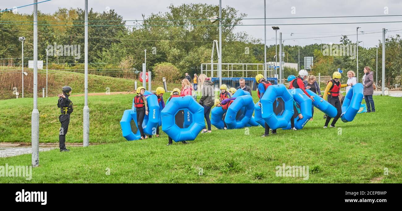 Goup of young people prepare for a rubber ring ride down the Nene ...