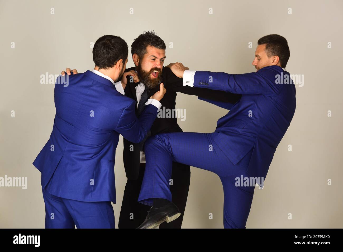 Leaders punch each other and argue on light grey background. Men with ...