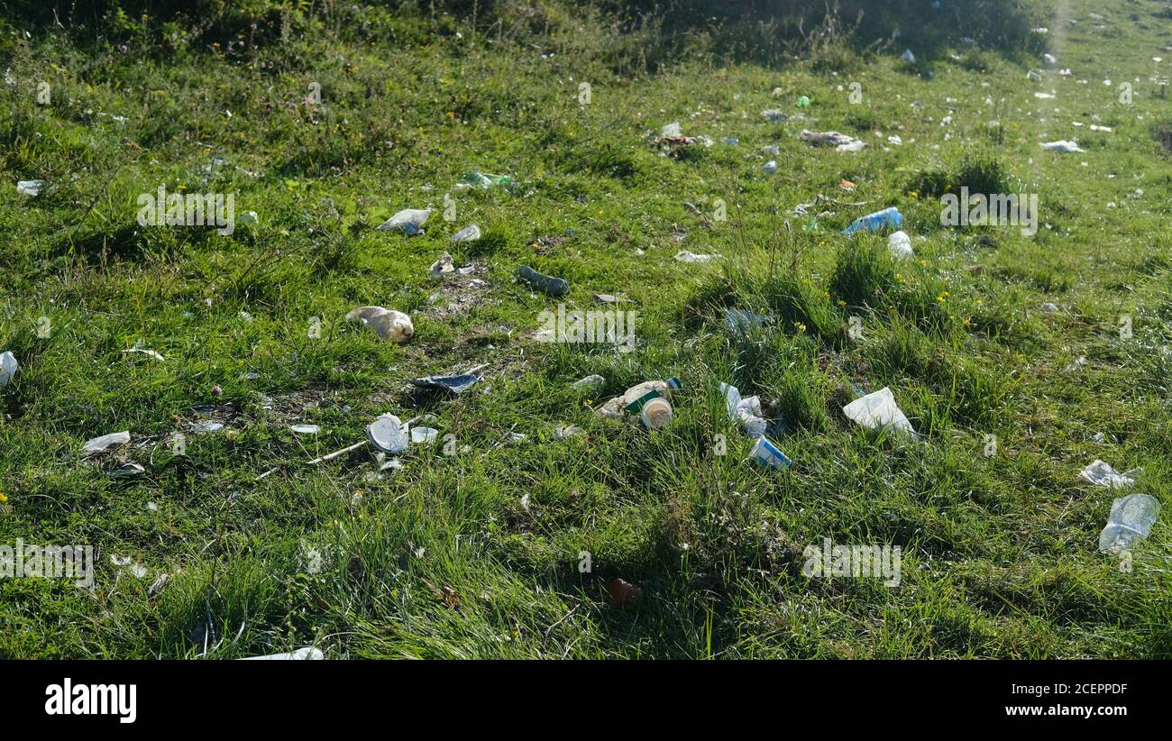 High angle shot of a grass field polluted with rubbish Stock Photo - Alamy