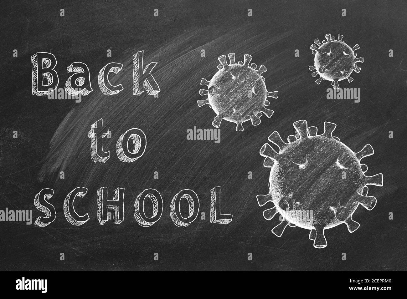 Hand drawing text "Back to School" on blackboard. Covid-19 concept ...