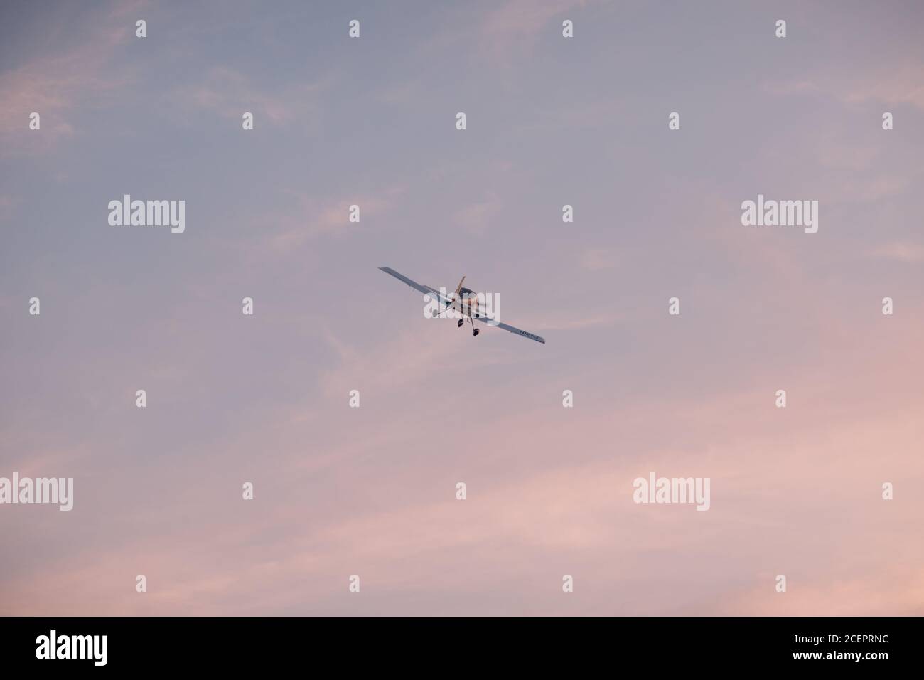 Small single engine airplane flying against sunset sky Stock Photo - Alamy