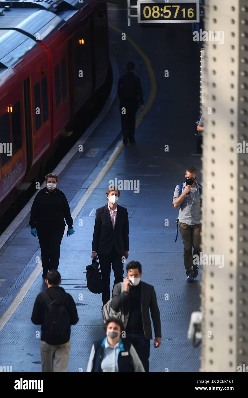 Commuters leave a train London's Waterloo station - which is one of the ...