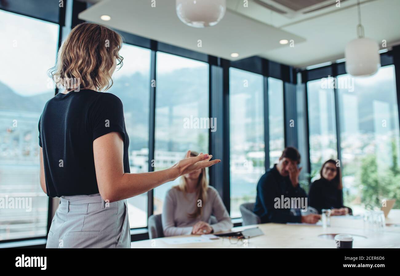 Businesswoman making a presentation to her colleagues in office. Female ...