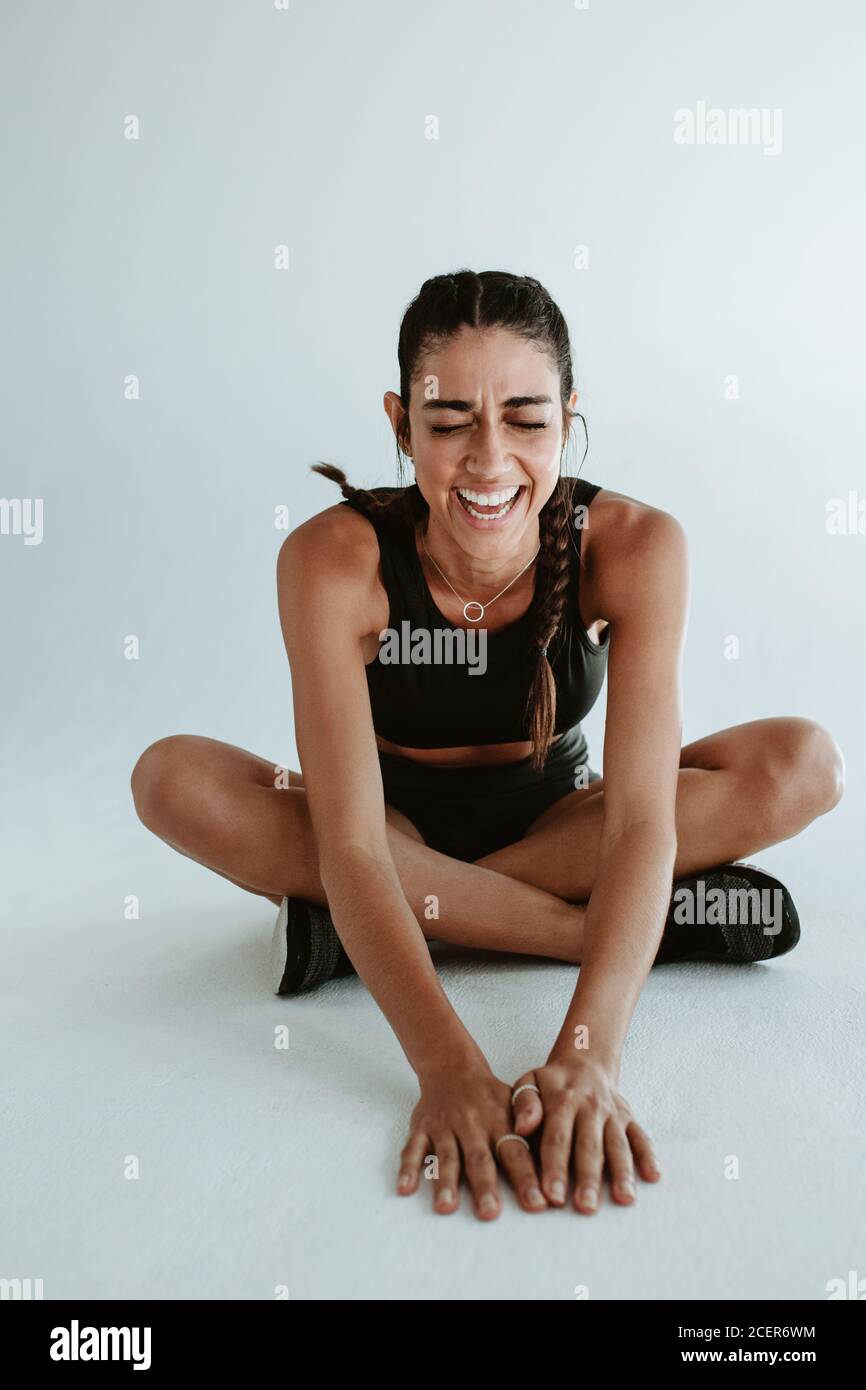 Cheerful woman stretches body sitting hi-res stock photography and ...