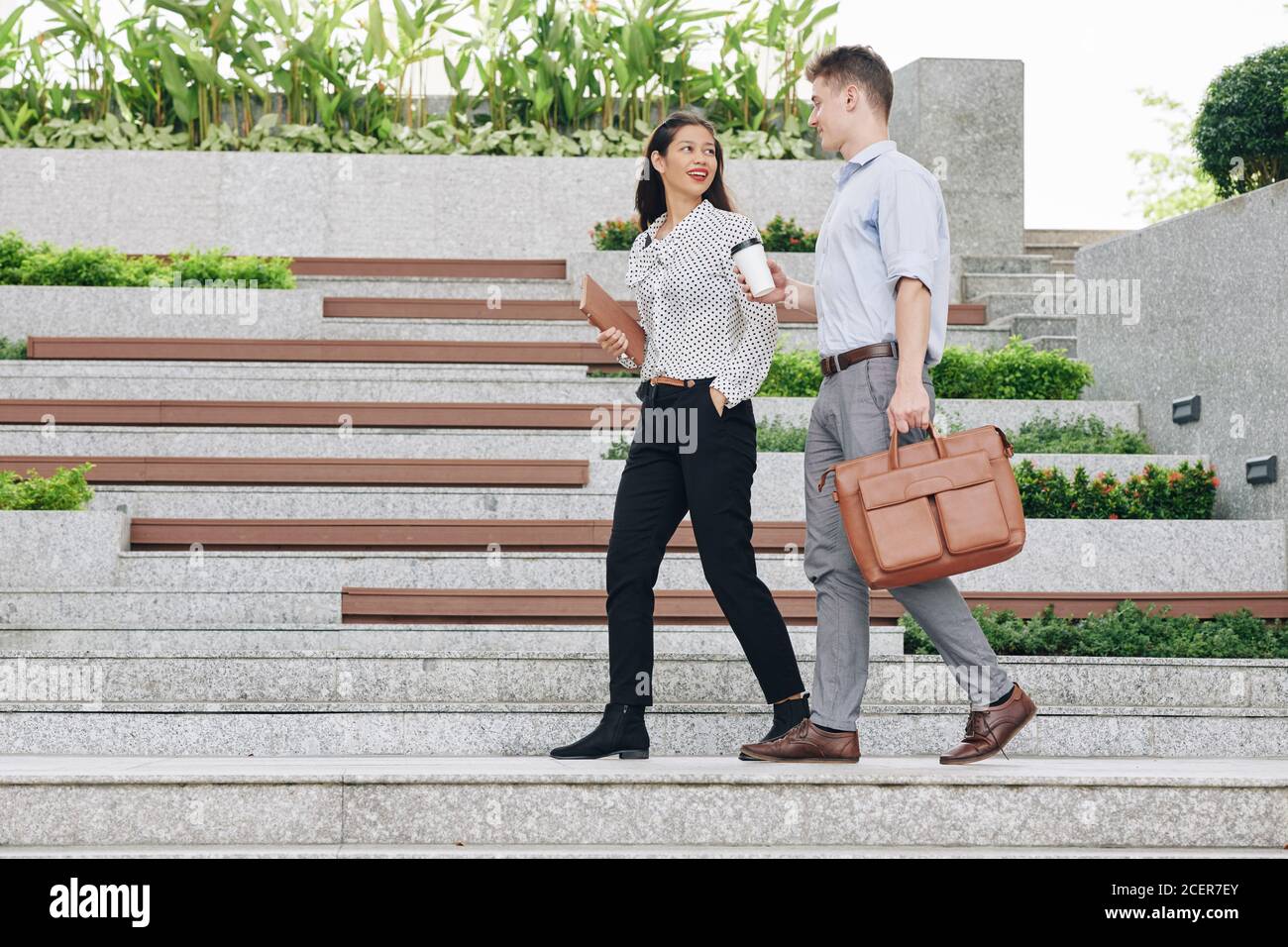 Male entrepreneur discussing walking hi-res stock photography and ...