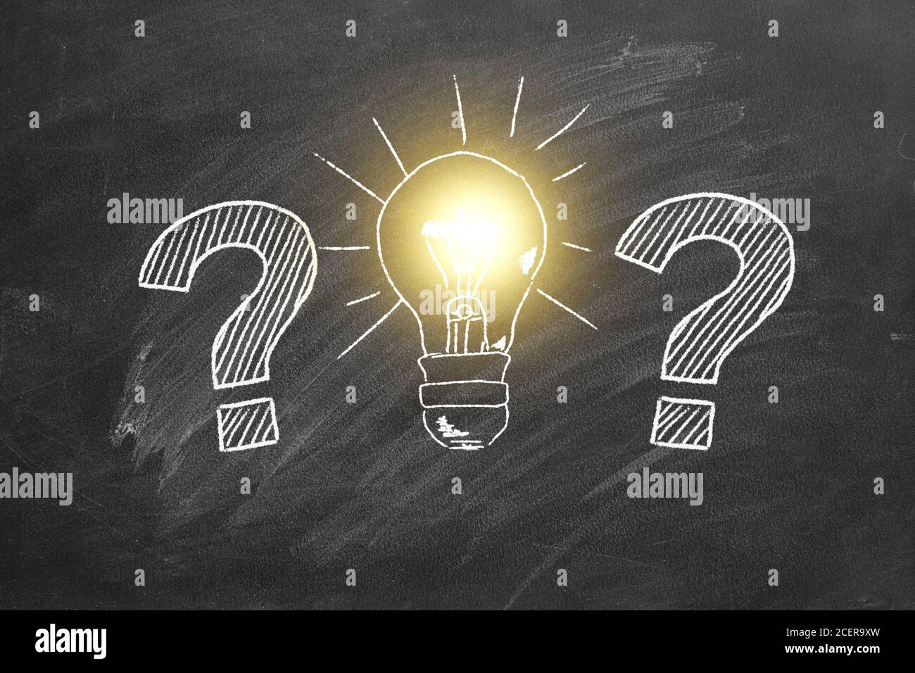 Two question marks turns into a light bulbs. Chalk drawing on a ...