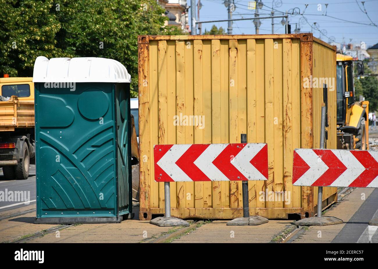Freight transportation container and a portable toilet on the street ...