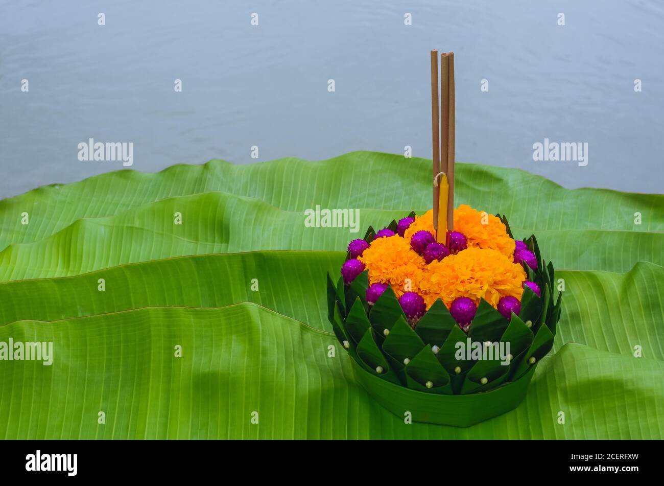Banana leaf Krathong that have 3 incense sticks and candle decorates ...
