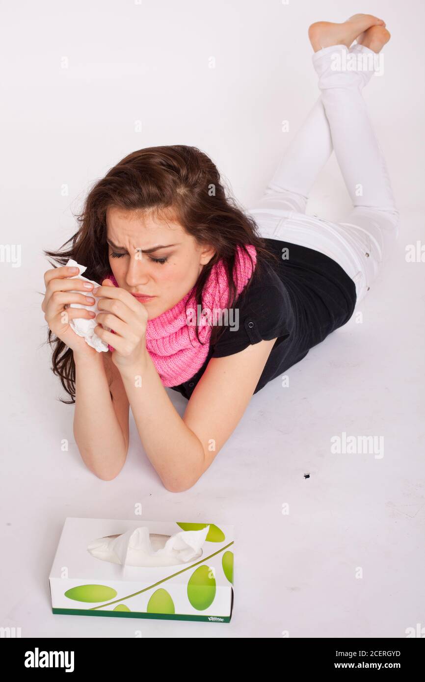 A beautiful young woman, lady, girl, cold, runny nose, headache ...