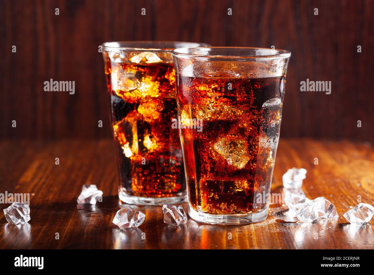 glass of cold cola soft drink with ice on wooden background Stock Photo ...