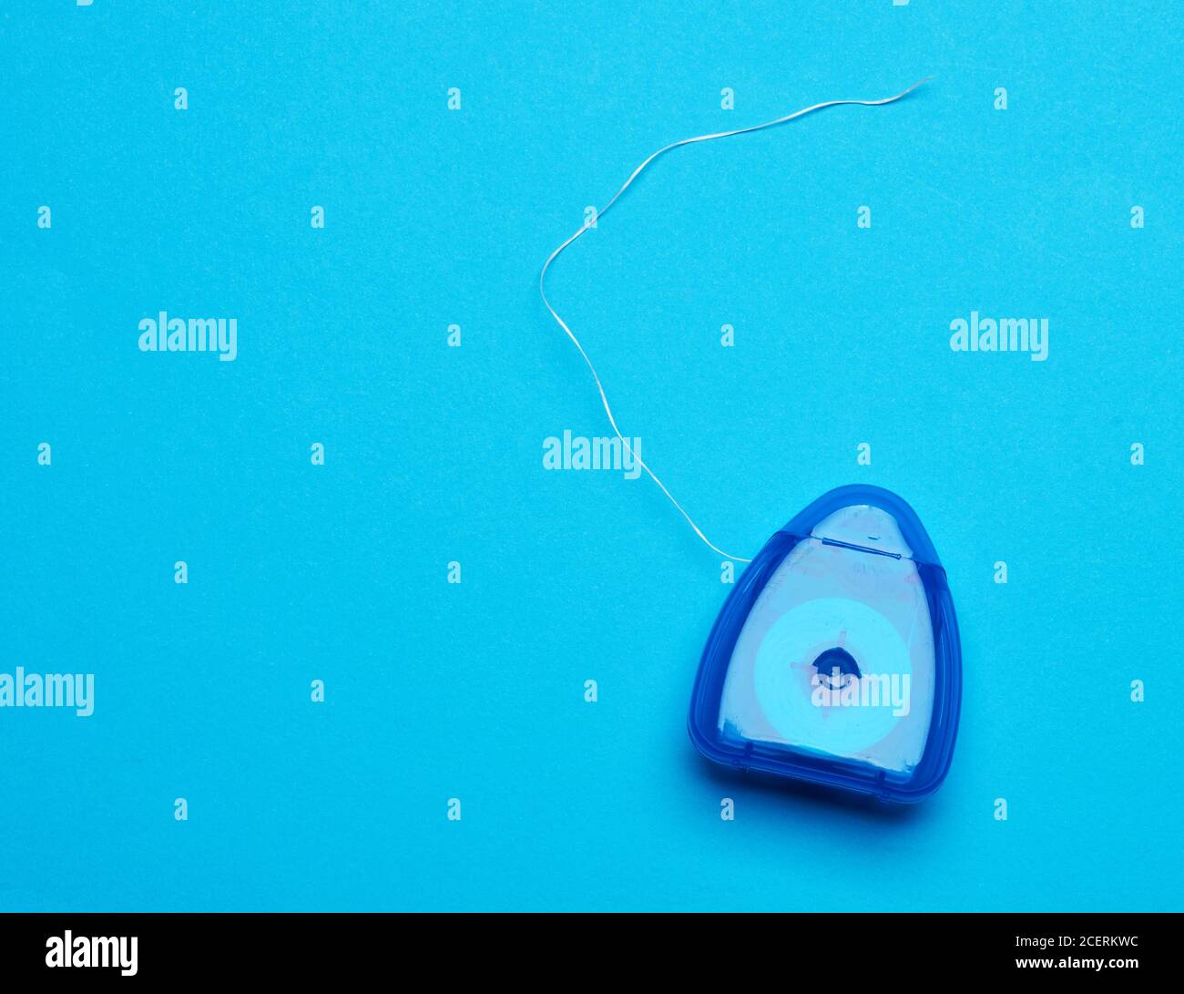 blue plastic packaging with dental floss on a blue background, close up ...