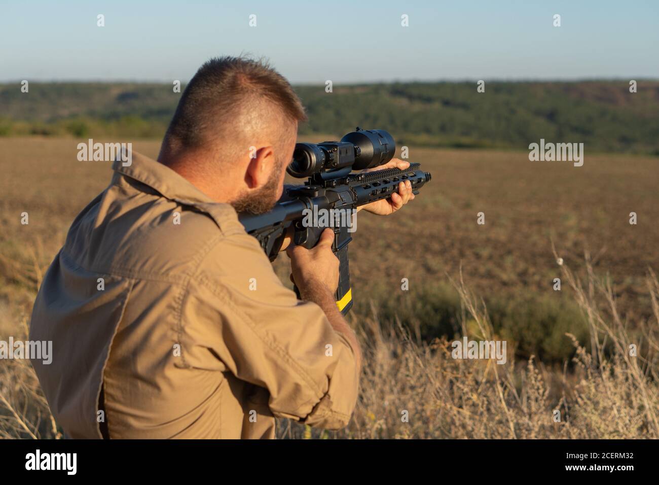 A hunter with a weapon on the hunt against the backdrop of a beautiful ...